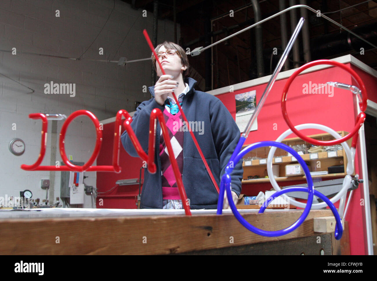 Amy Palms, Neon tube glass bender and artist, looks at a glass tube for ...