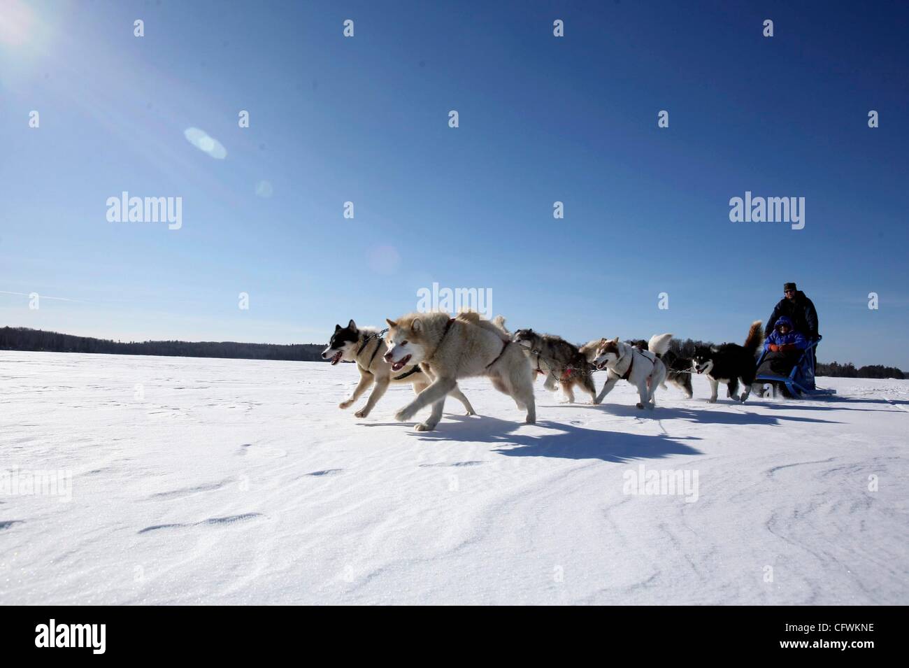 David Gossage mushes a sled with a passenger, Alice Wagner, 78, of ...