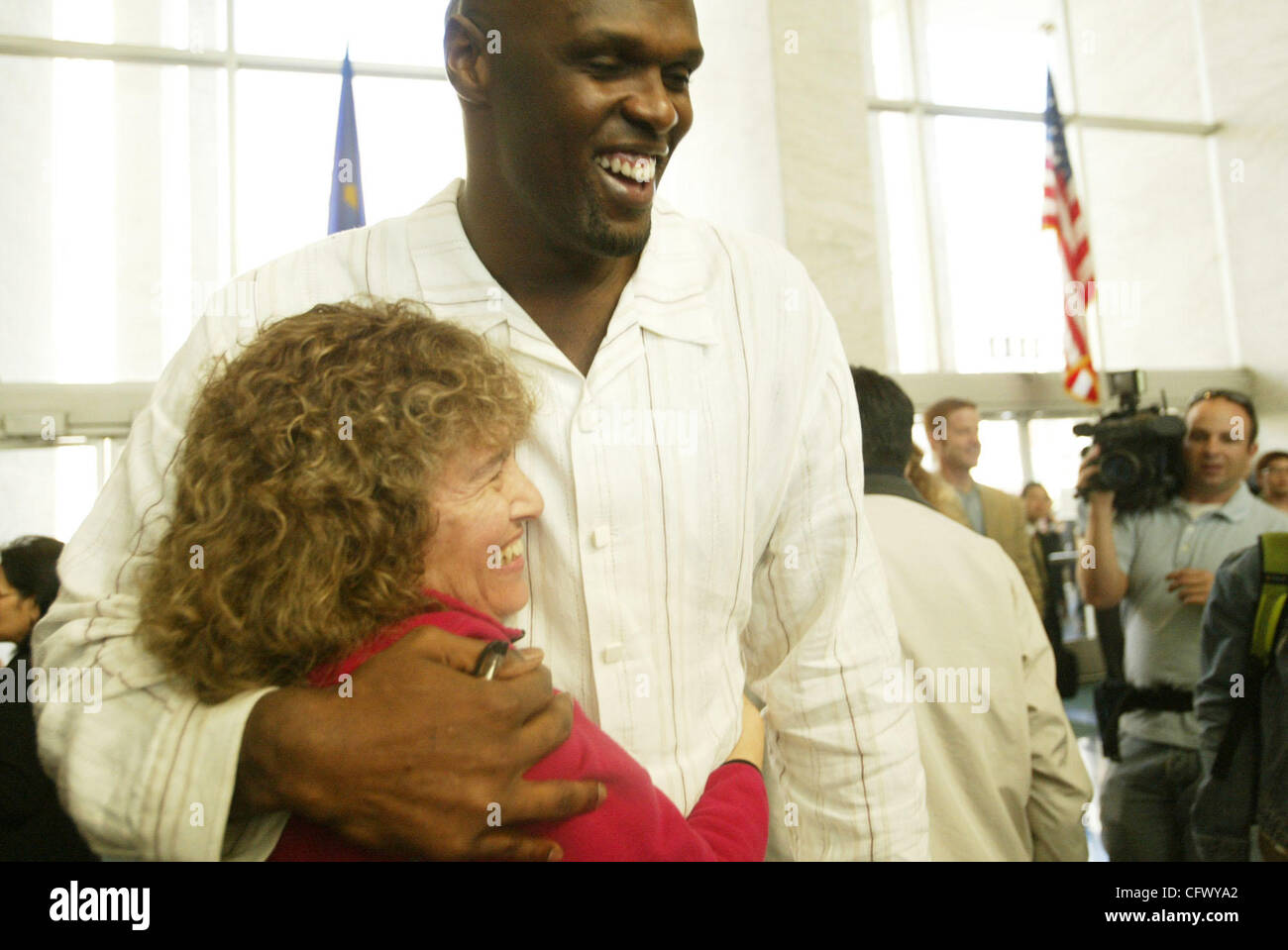 Golden State Warriors' center Adonal Foyle gets a hug from his adoptive ...