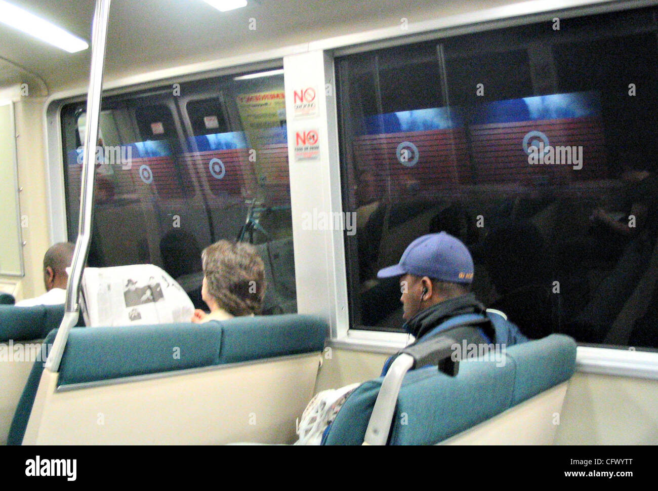 Passengers on a BART train ignore the new "motion picture" advertising ...