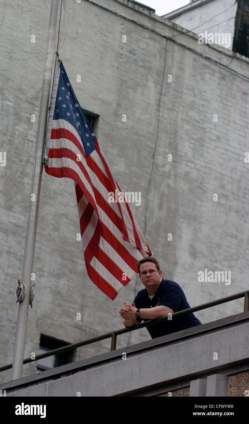 An unidentified police officer stands on the roof of the 6th Precinct ...