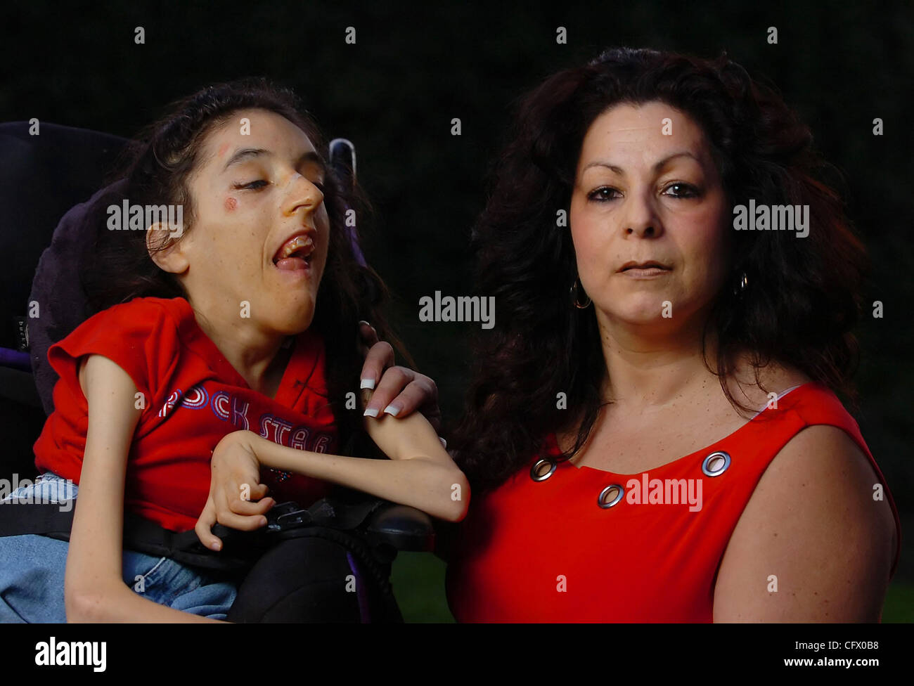 (L-R) Shelly Guinn, age 27, sits next to her mother Annette Olguin ...