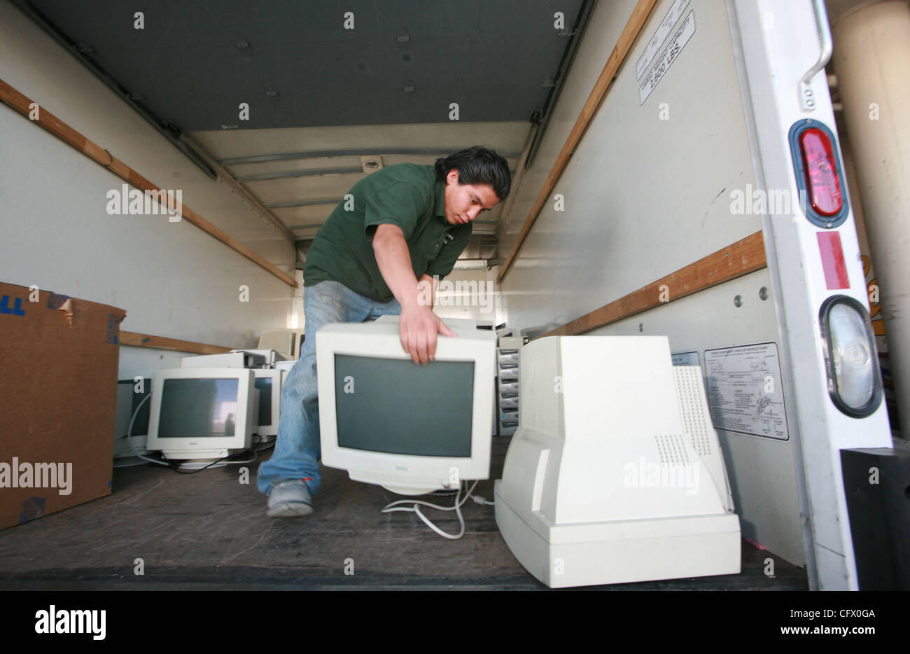 Omar Sanchez, an employee of Direct Computer Disposal, unloads a truck ...