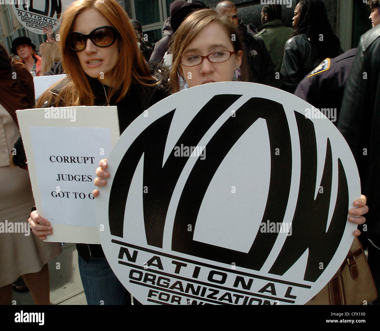 Bridget Marks (L) and Elizabeth Pinto (R) holds up a signs as the ...