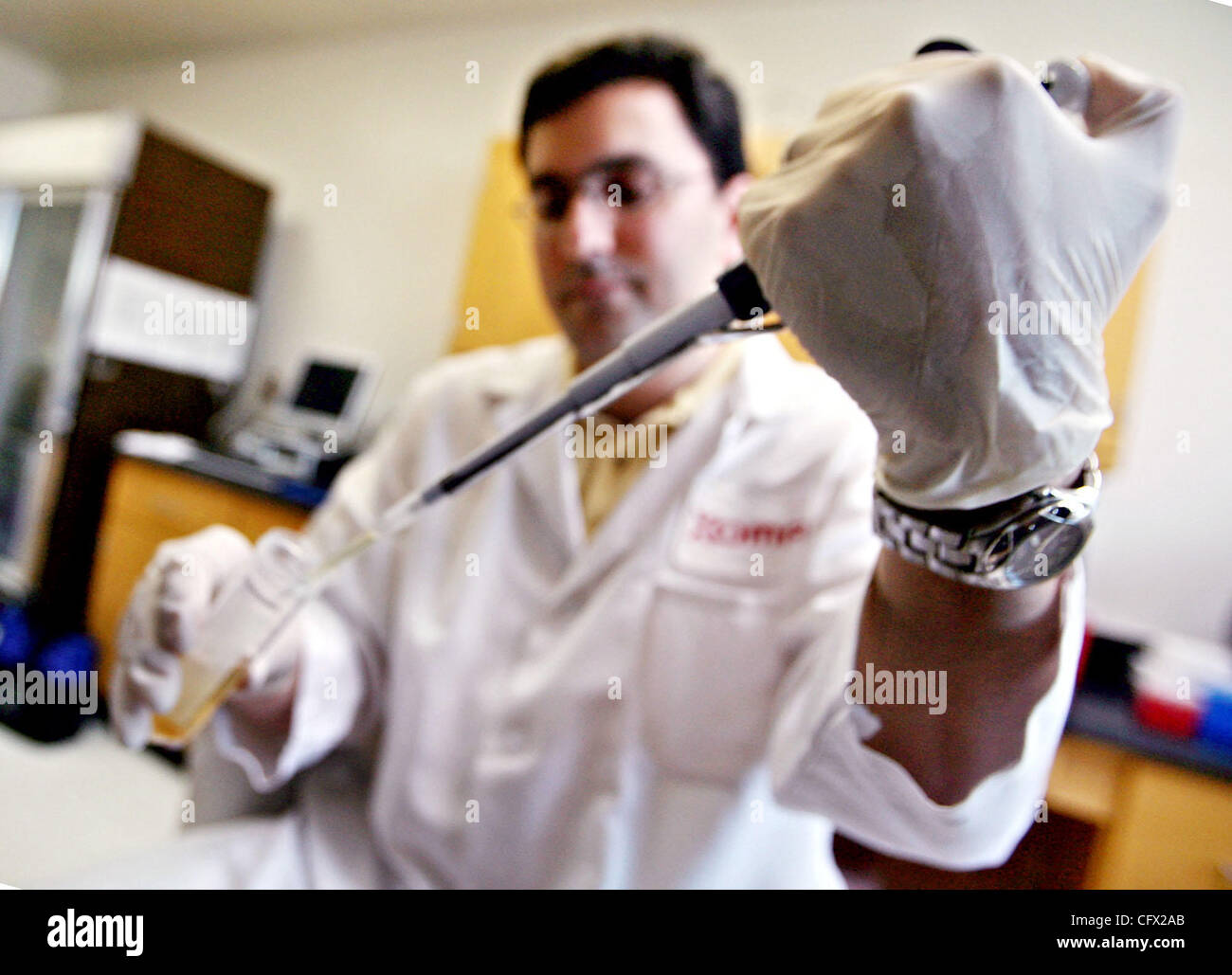 Raphael Levy, a scientist at Xoma, transfers media growth for bacteria ...