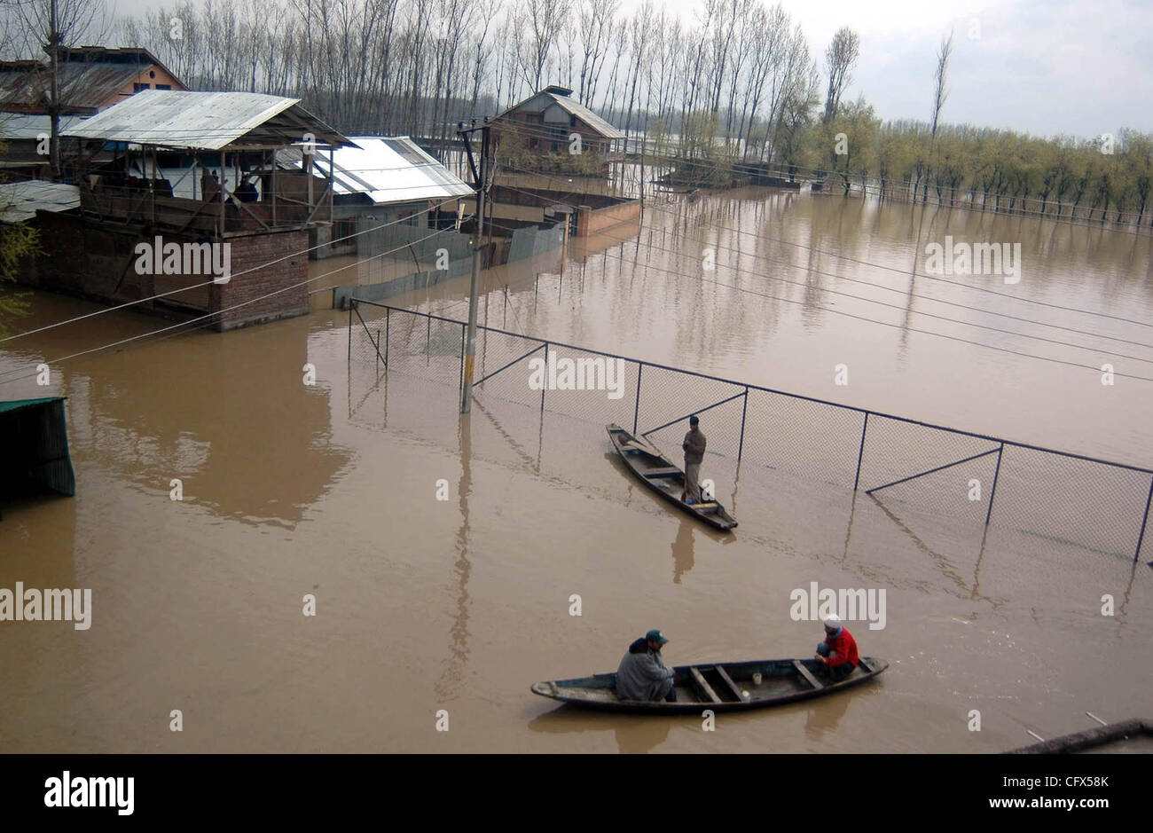 Kashmiri people ride thir shikaras to reach their houses in a flooded ...