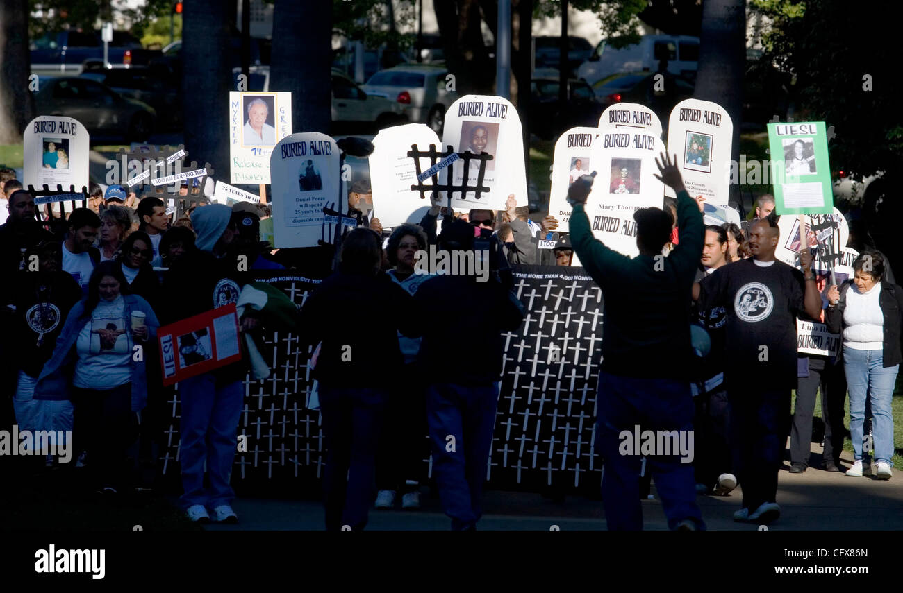 Marchers holding signs of loved ones who were sentenced to 25 years to ...