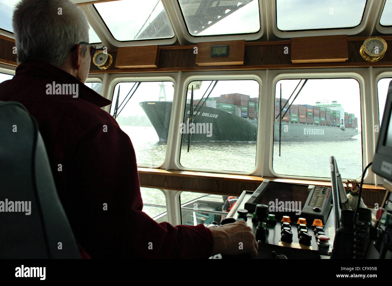 Tugboat operator Jan Tiura waits on a container ship she will help dock ...