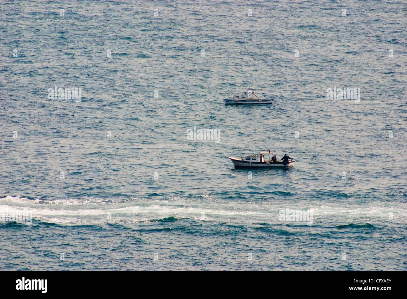 Fishing boats work in the Turkish Straits in the middle of Istanbul ...