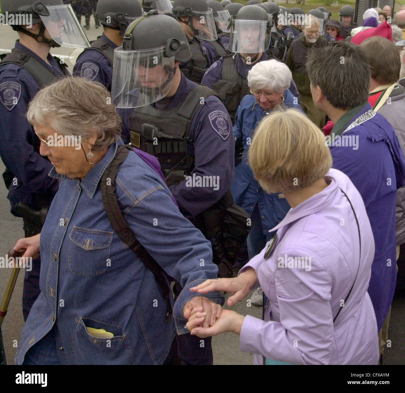 A woman comforts another woman as they are led into custody during the ...