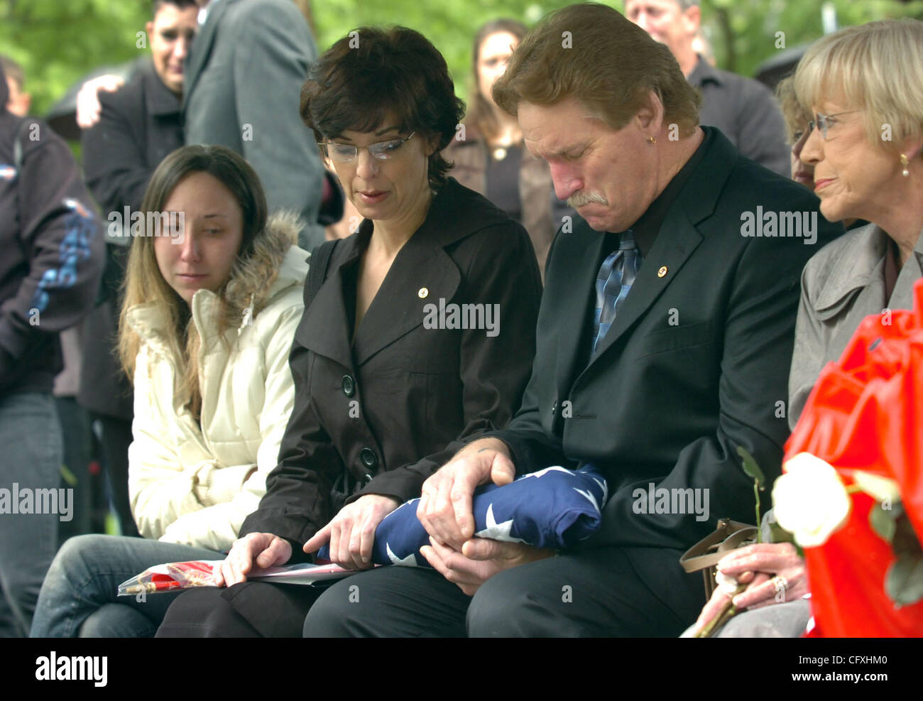 Marie and Jim Coon, parents of Spc. James Coon, accept the American ...
