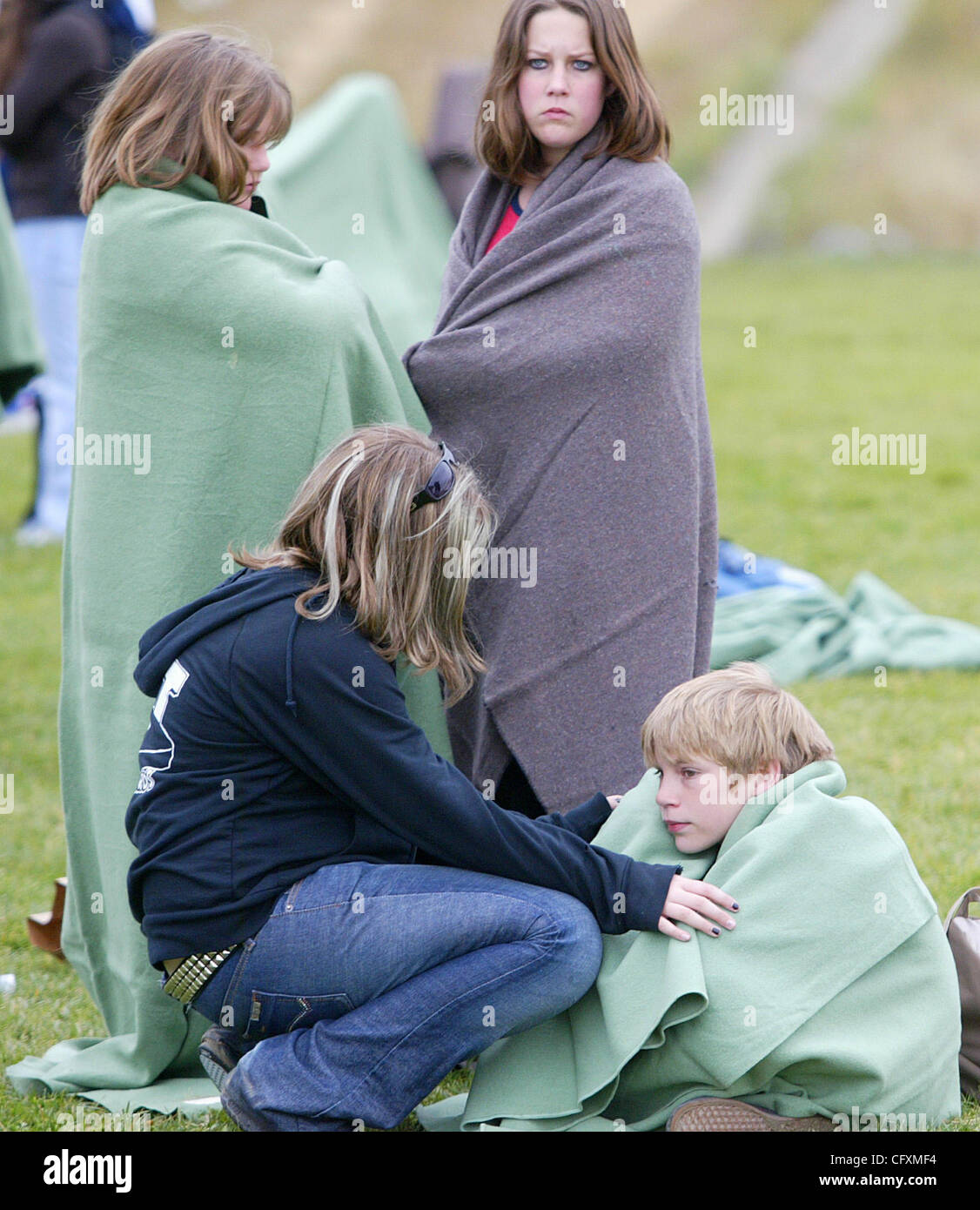Stundents huddle together in blankets on the football field of Canyon ...