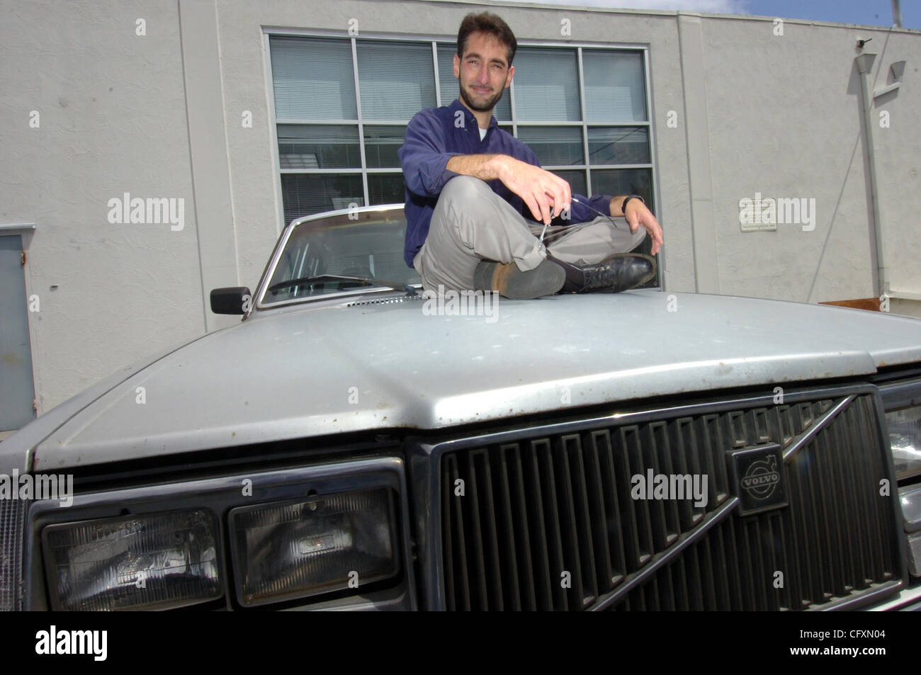 Kevin Epstein sits on the hood of his Volvo at his Scalent Systems ...