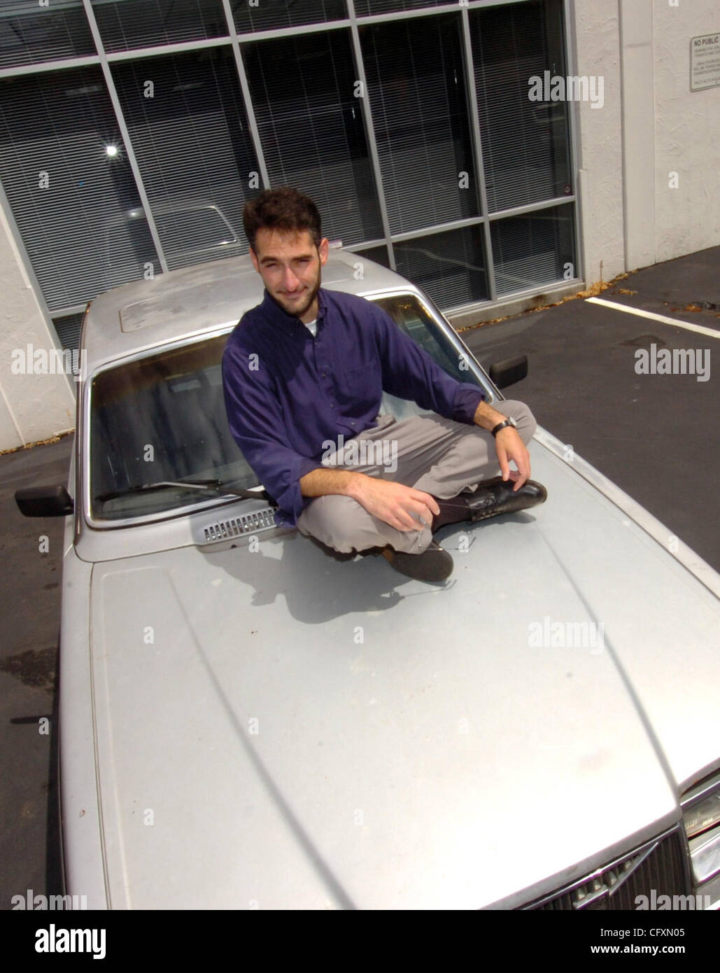 Kevin Epstein sits on the hood of his Volvo at his Scalent Systems ...