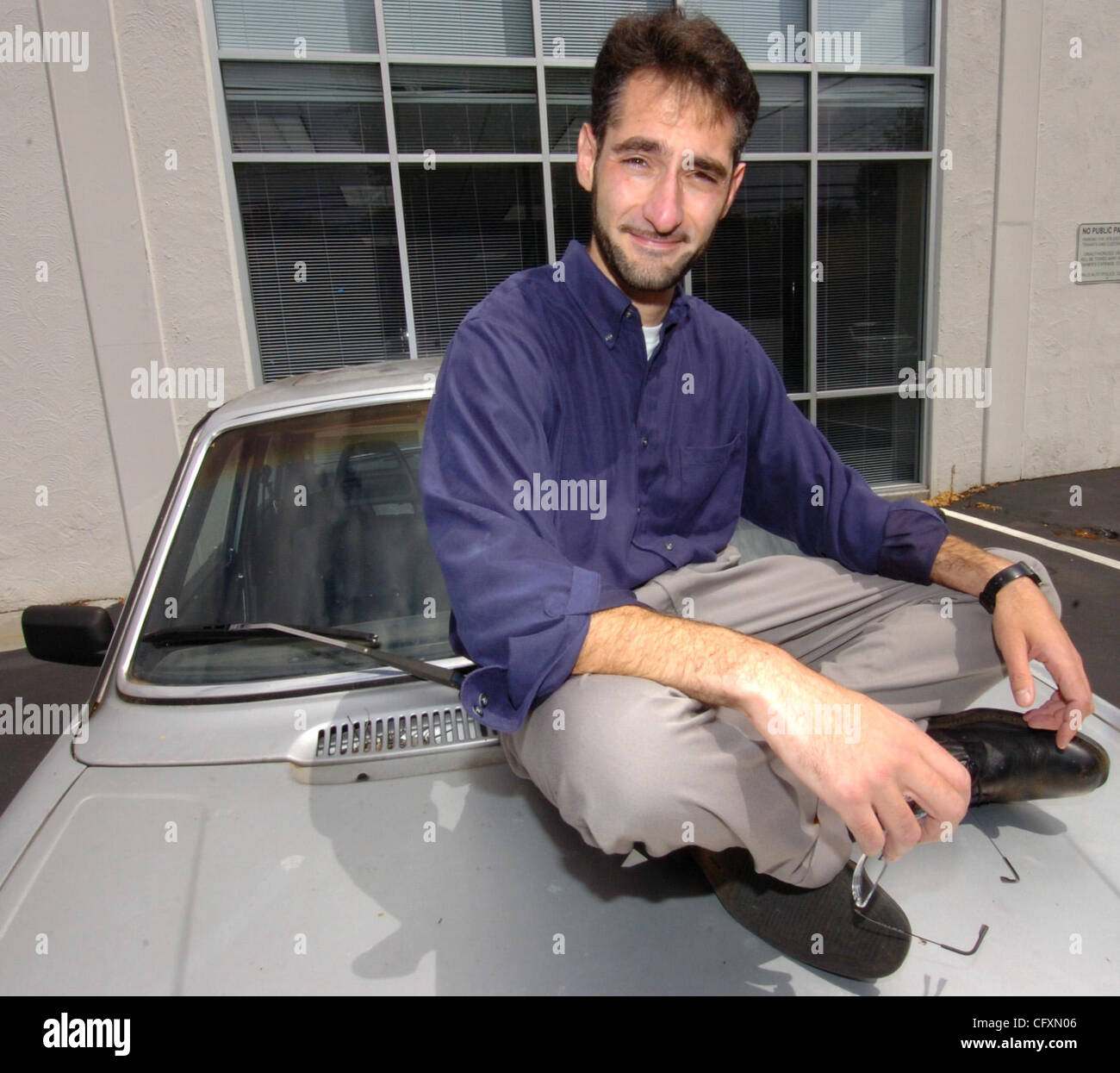 Kevin Epstein sits on the hood of his Volvo at his Scalent Systems ...
