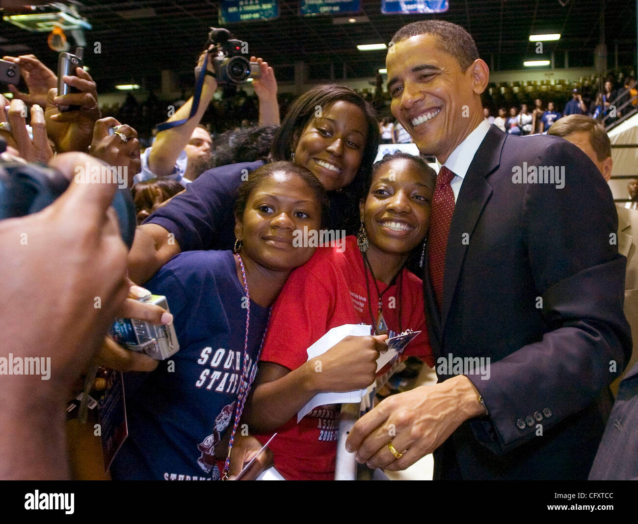 Illinois Senator Barack Obama (R) has his picture taken with students ...