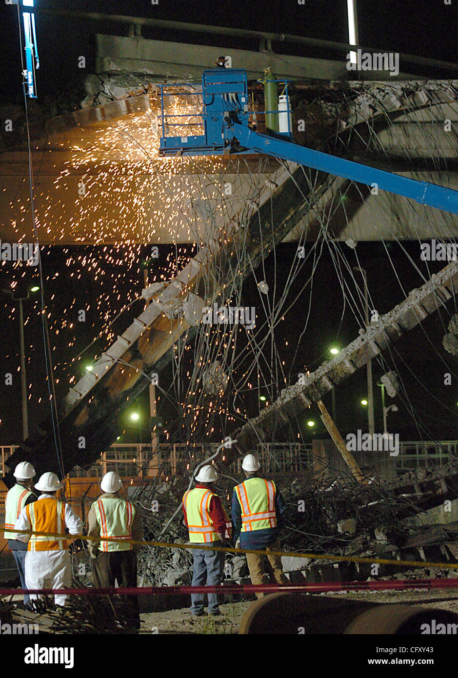 A worker helping with the initial clean-up process on the collapsed ...