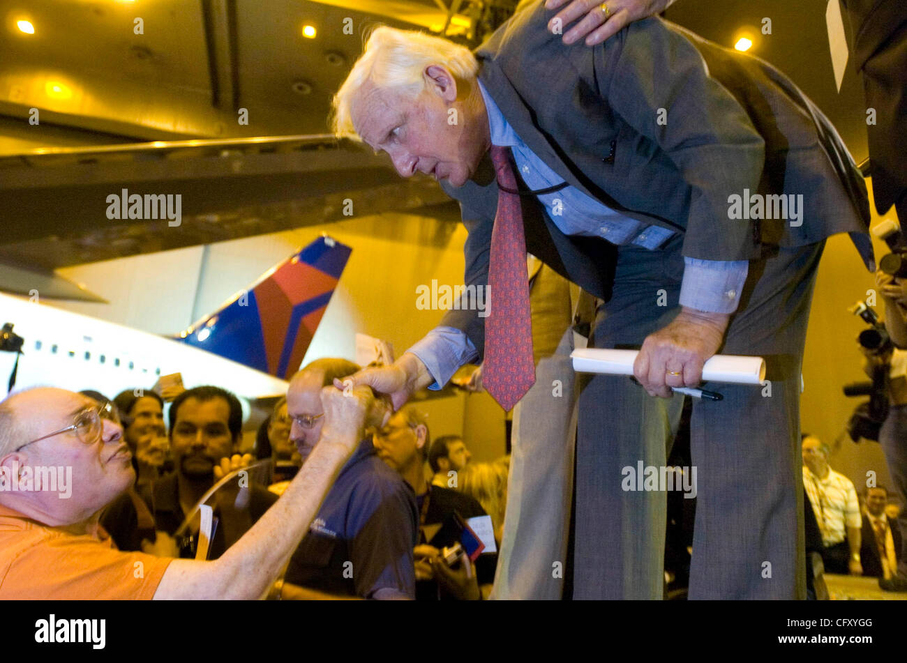 Delta Air Lines CEO Gerald Grinstein (R) greets employees with a newly ...