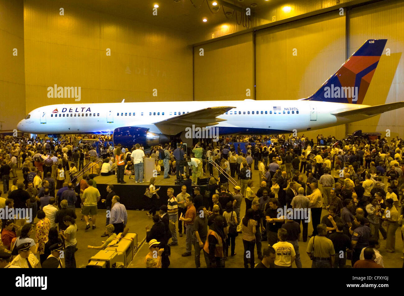 Delta Air Lines employees gather around a newly painted Boeing 757 jet ...