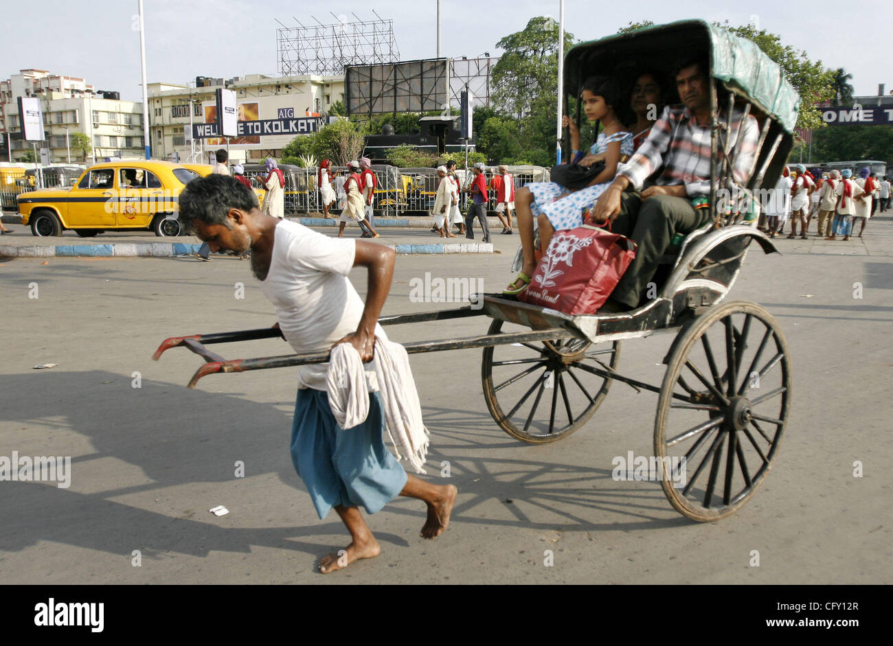 A rickshaw puller carrying a customer on the occasion of International ...
