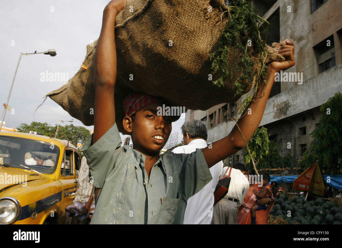 An young Indian labourer carries load on his head on the occasion of ...
