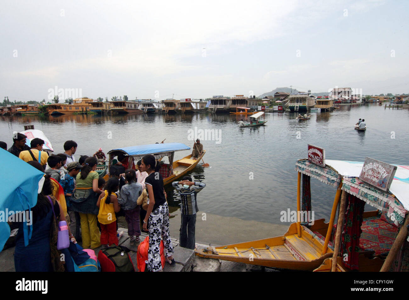 Tourists Stand on bank of dal-lake as they enter into shikaras for a ...