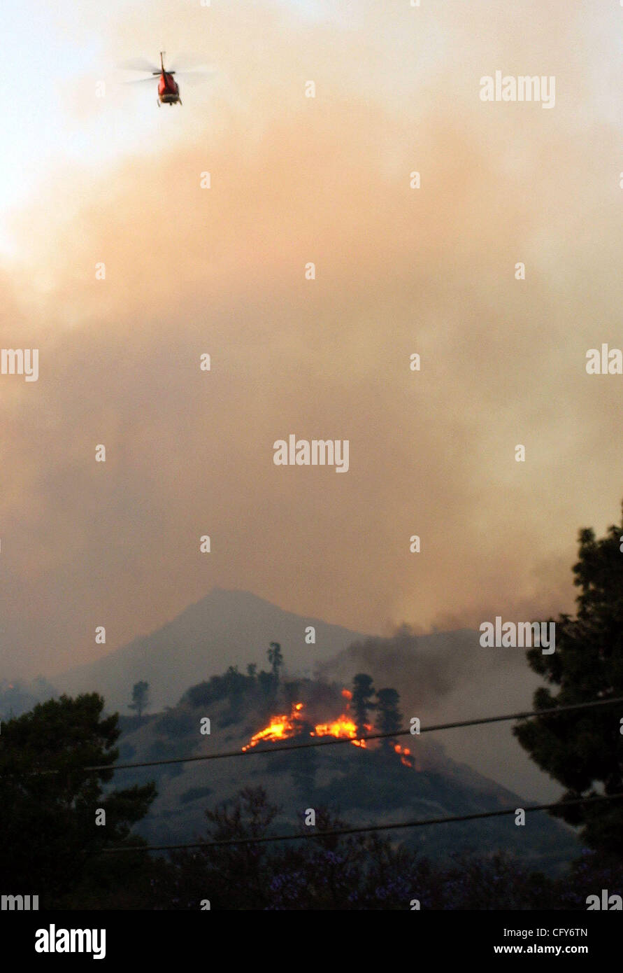 A Los Angeles Fire helicopter flies over during a brush fire in ...