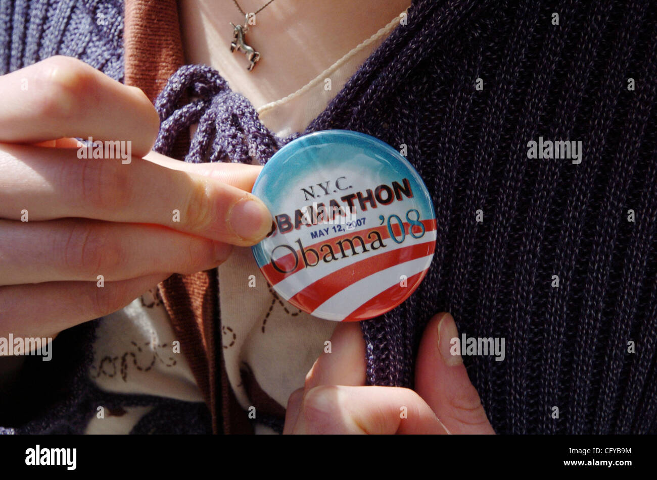 A woman attaches a campaign button as supporters of Senator Barrack ...