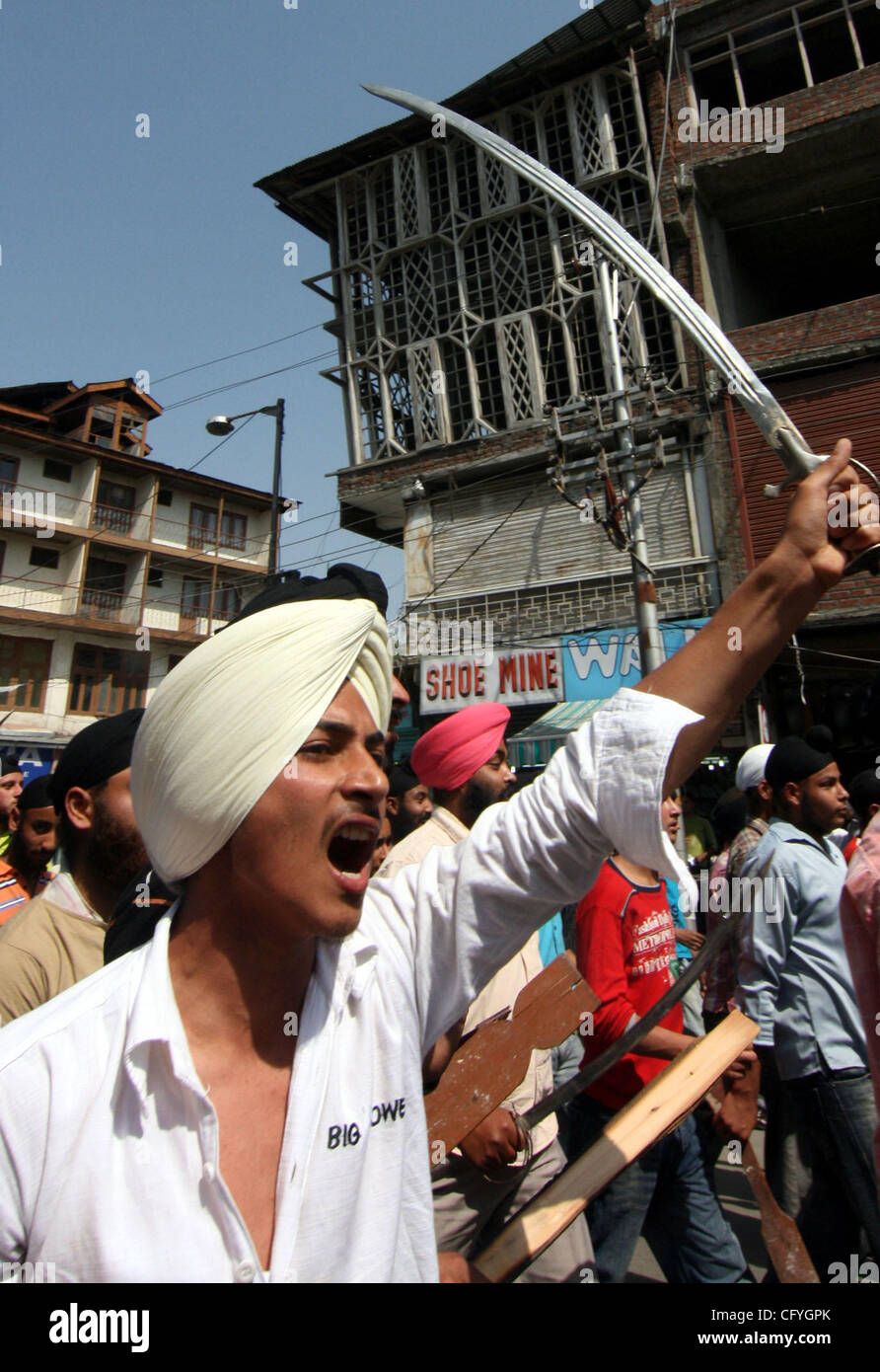 Sikh protersters brandishing swords knives and sticks shout slogans ...