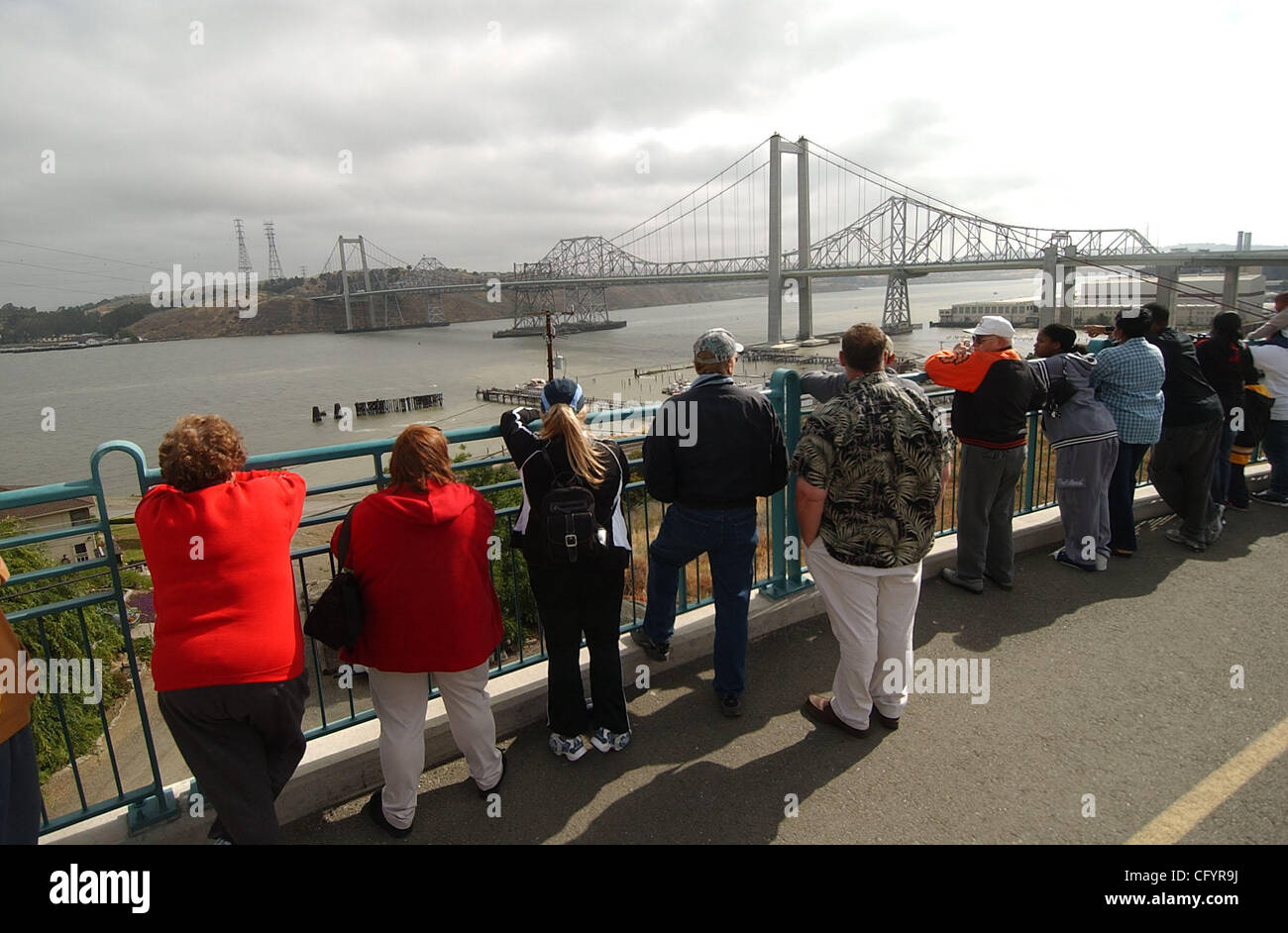 Whale watchers line the railing at the Carquinez Bridge overlook as two ...