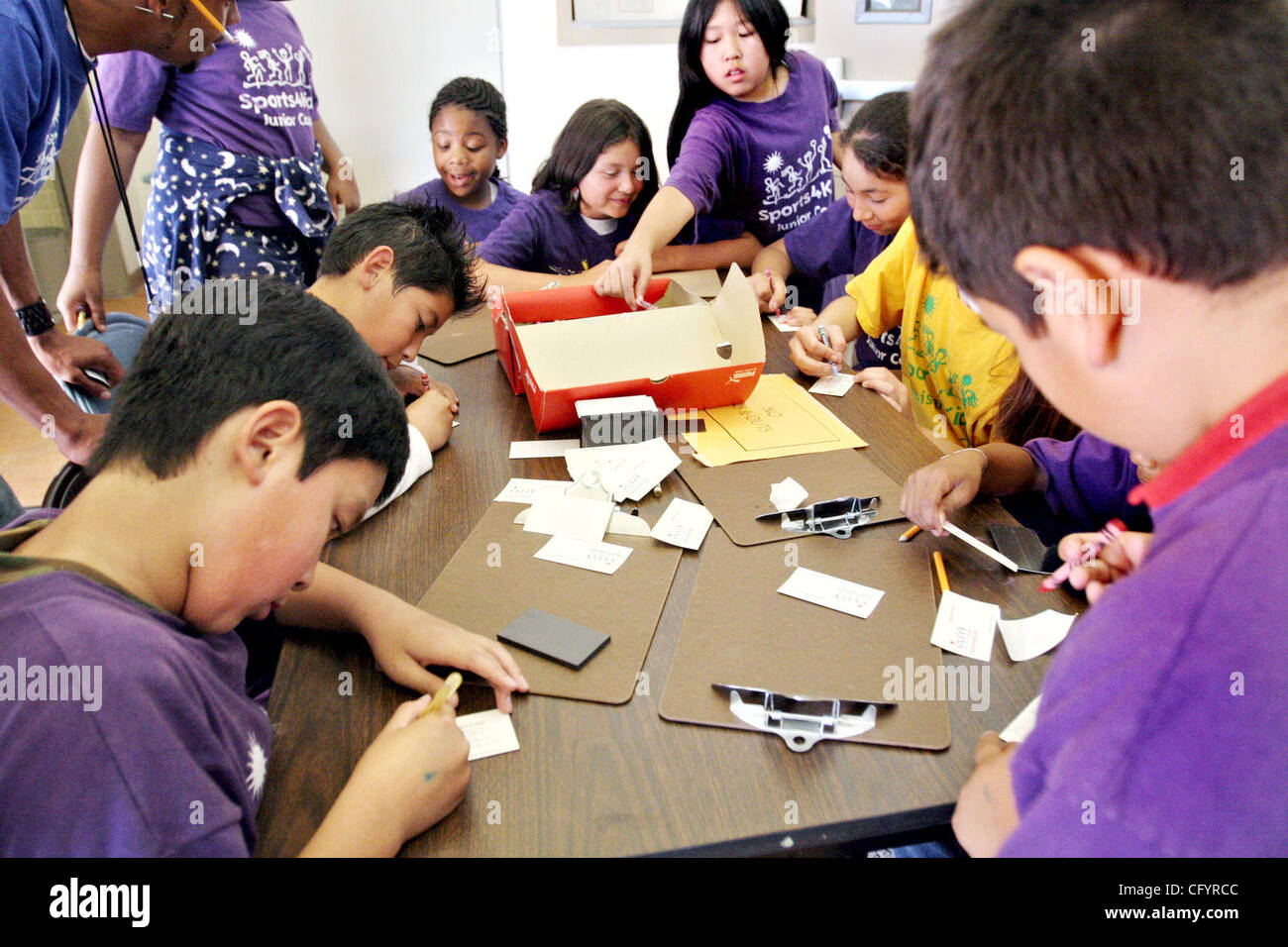 Fifth graders work on their business cards during the Junior Coach ...
