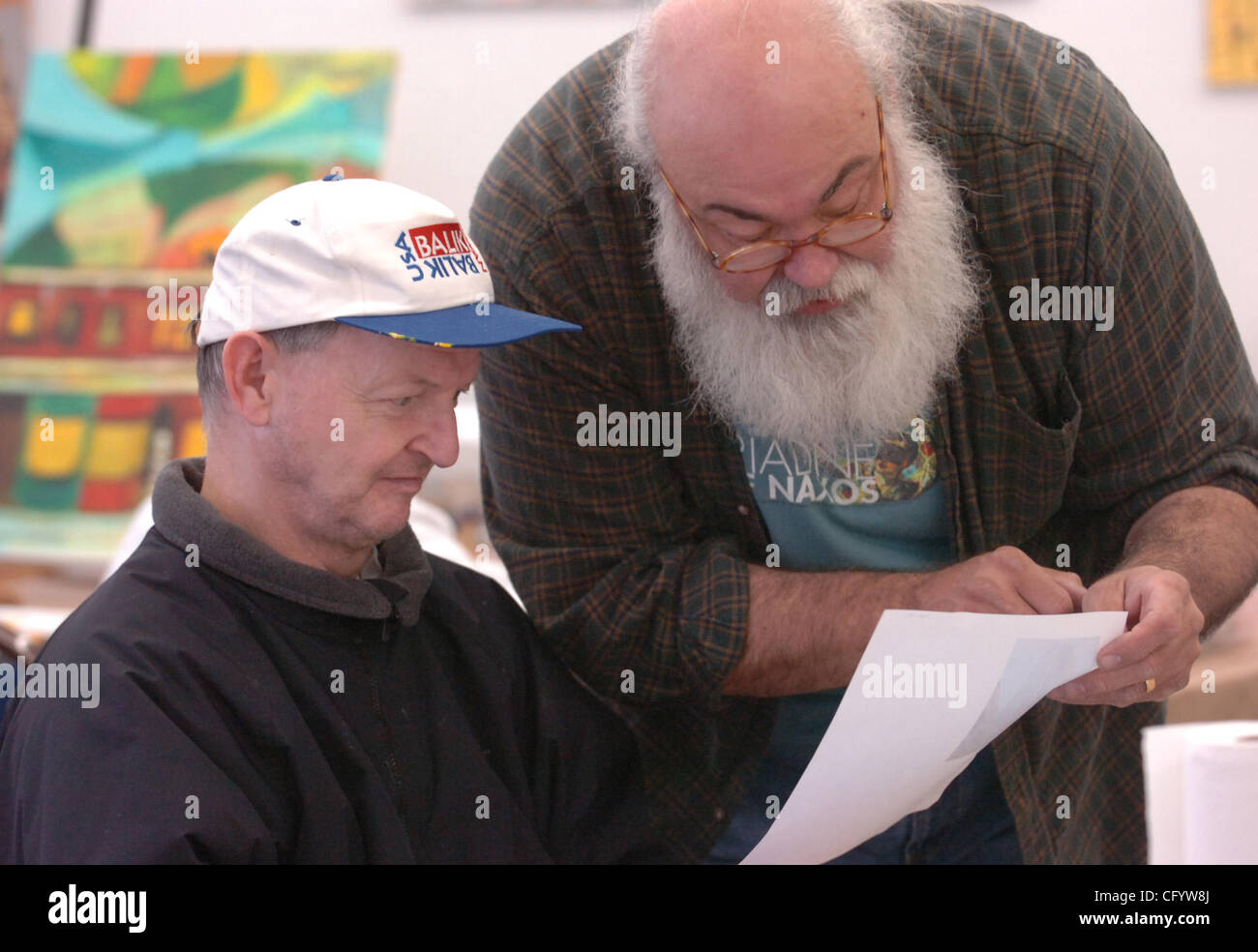 Instructor Miles Stryker, right, comments on artwork created by student ...