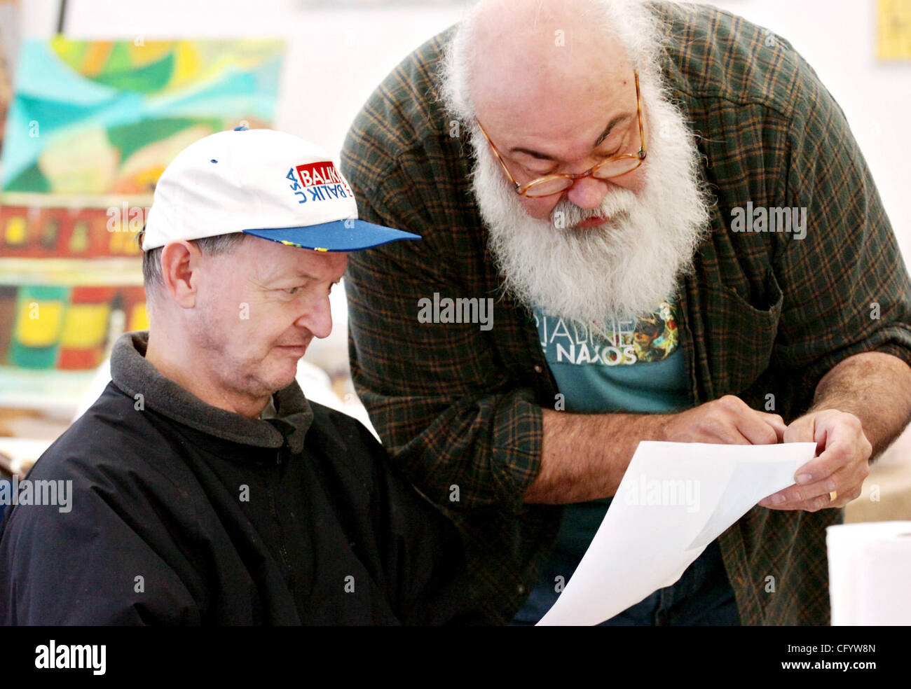 Instructor Miles Stryker, right, comments on artwork created by student ...