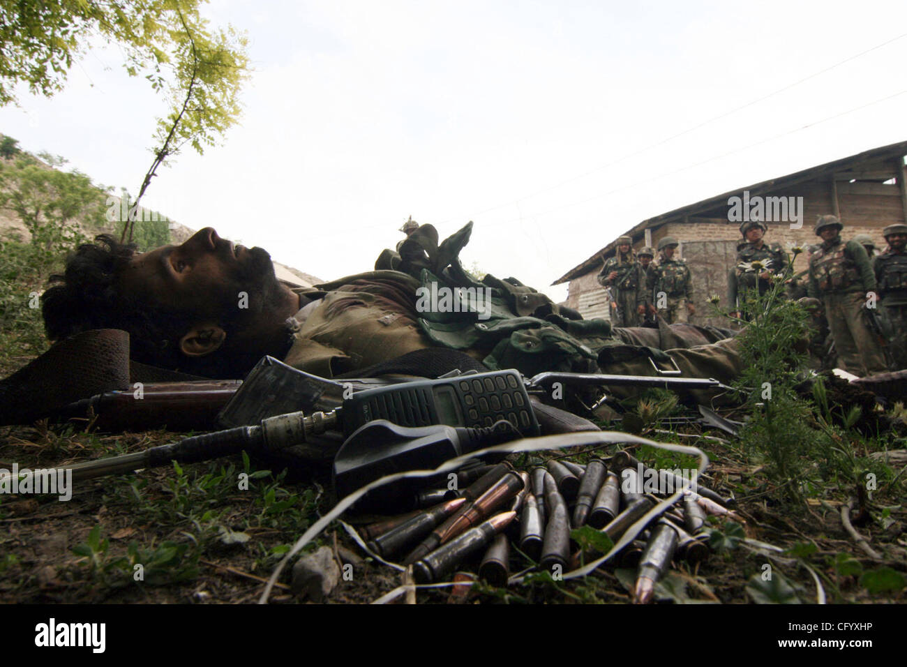 Indian army soldier stand near the body of a separatist militant during ...