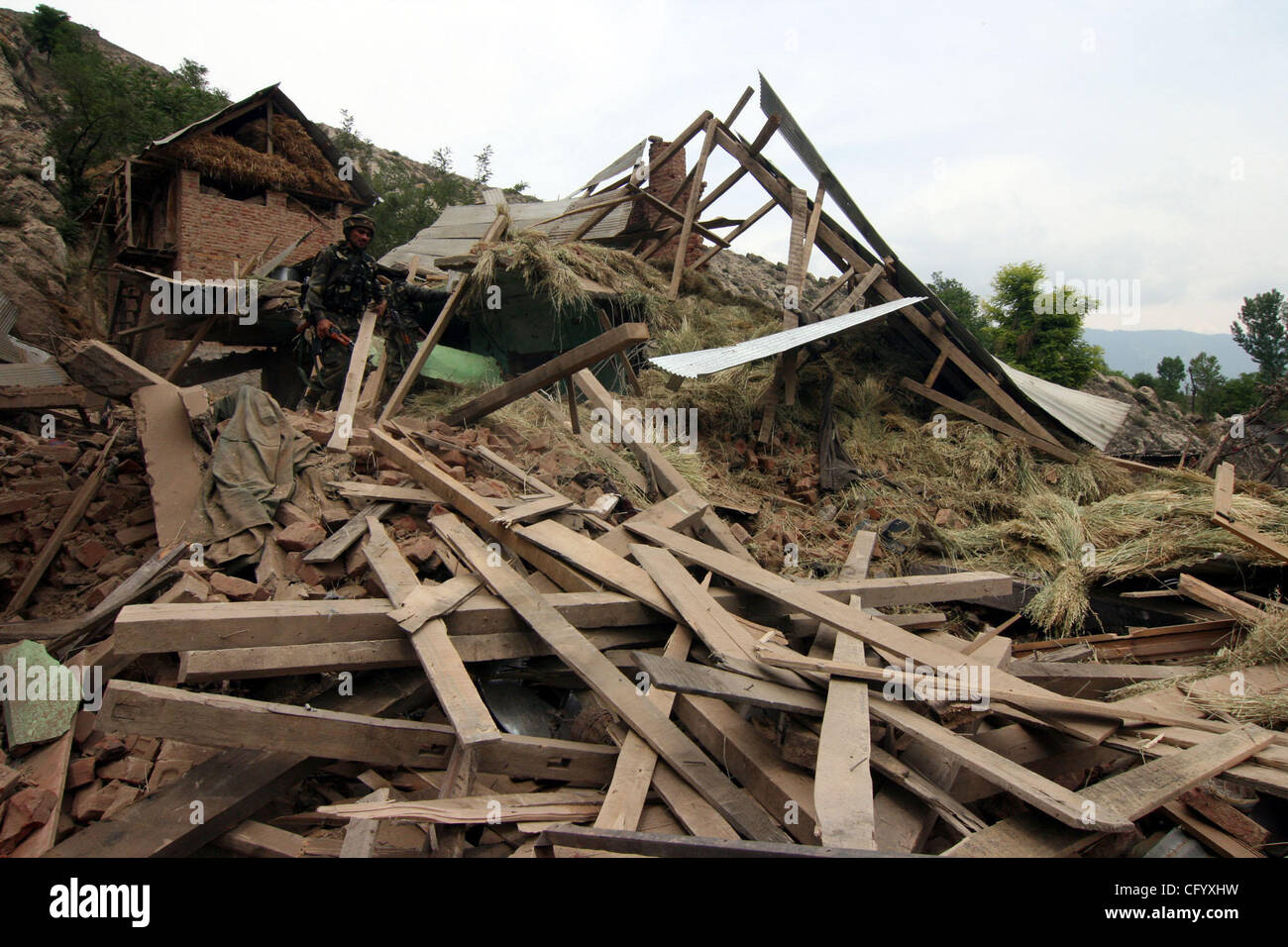 Indian army soldiers search the bodies of separatist militants among ...