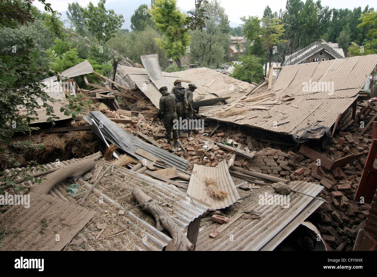 Indian army soldiers search the bodies of separatist militants among ...