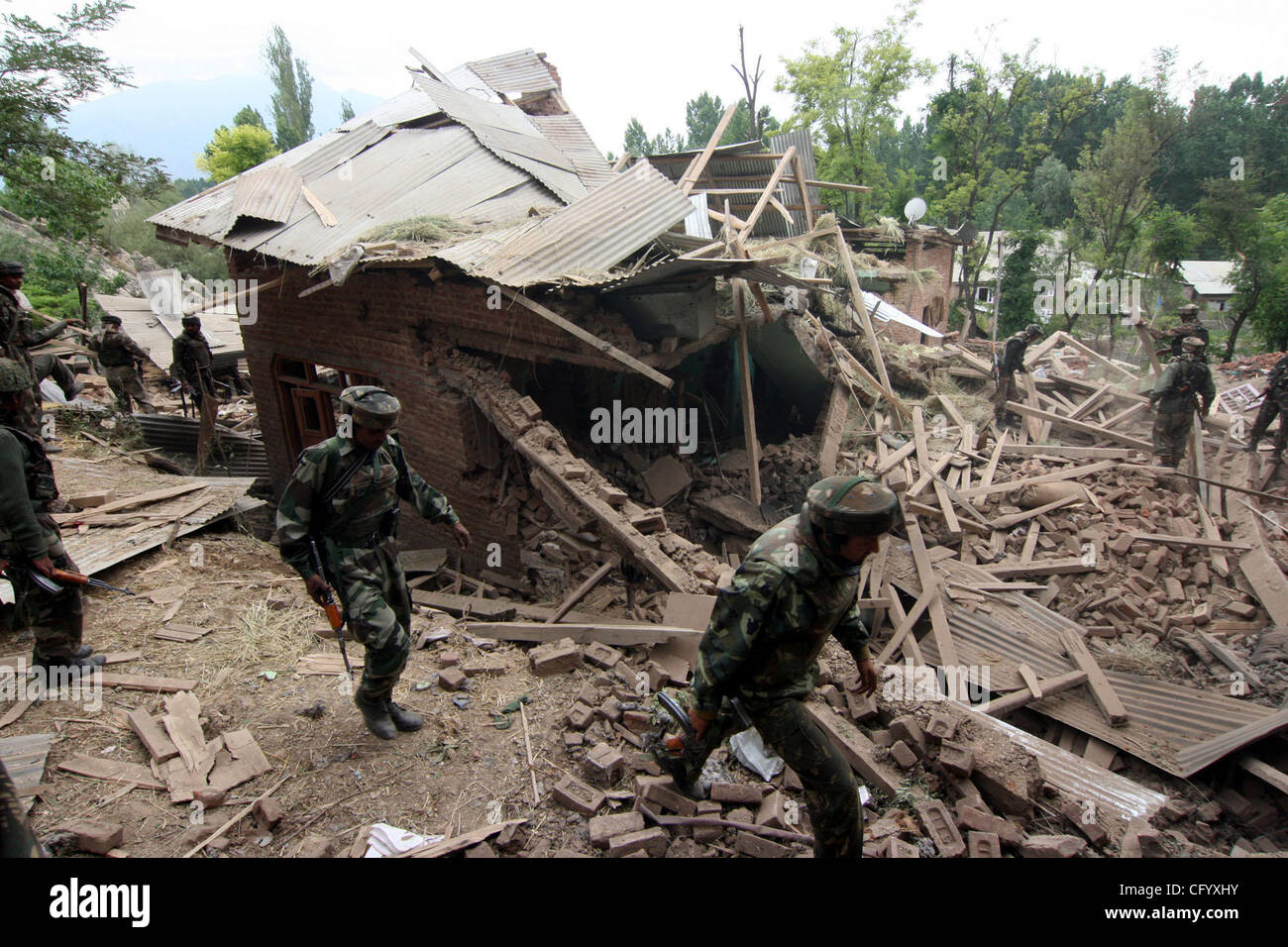 Indian army soldiers search the bodies of separatist militants among ...
