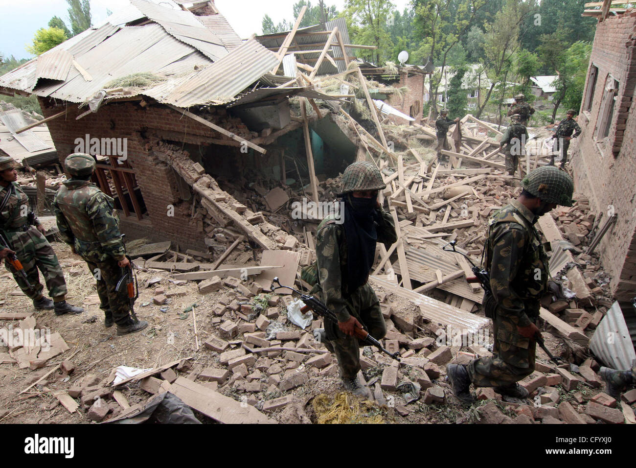 Indian army soldiers search the bodies of separatist militants among ...