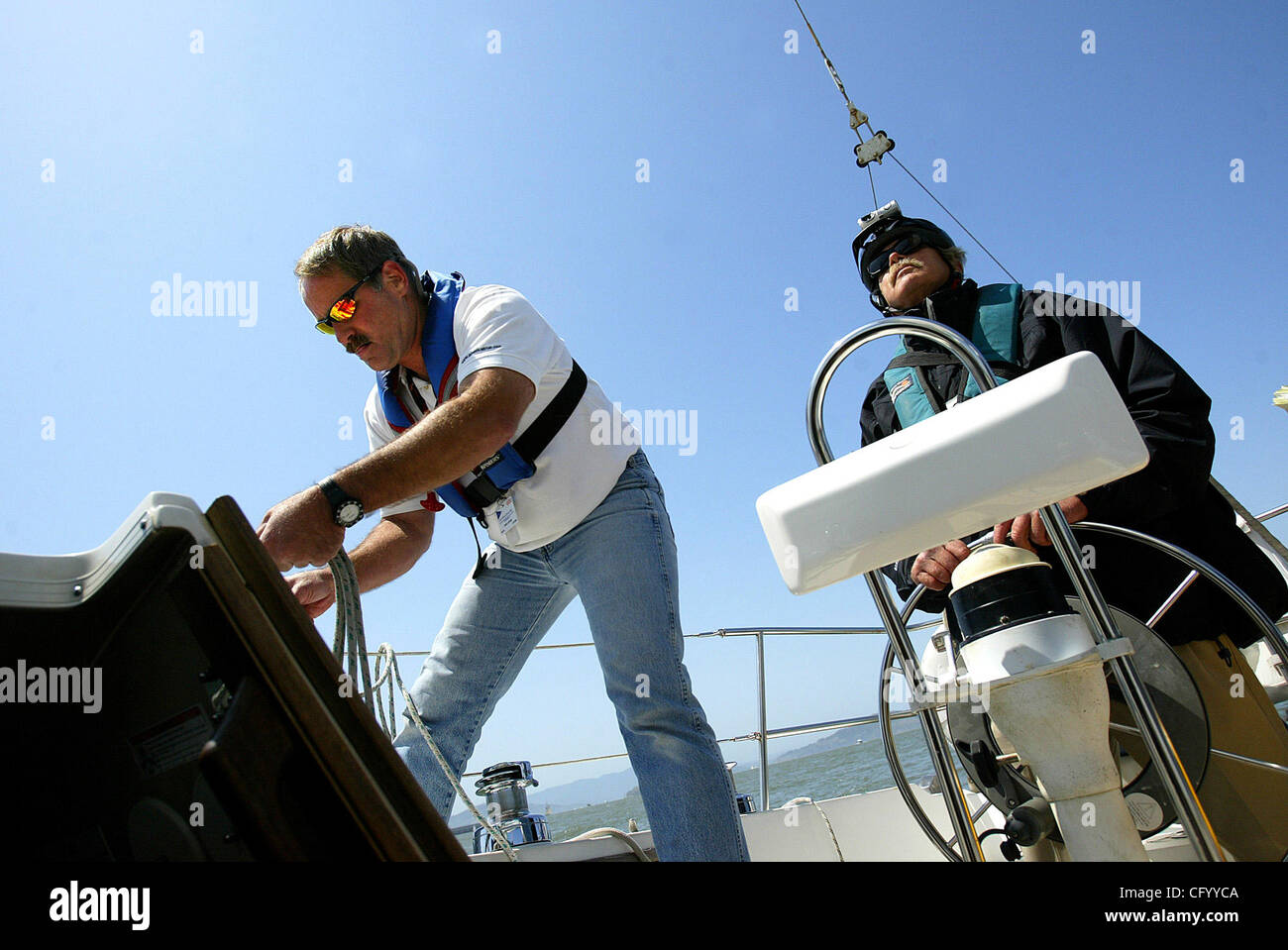 Ed Gallagher sails on San Francisco Bay while navigator Dan Leininger ...