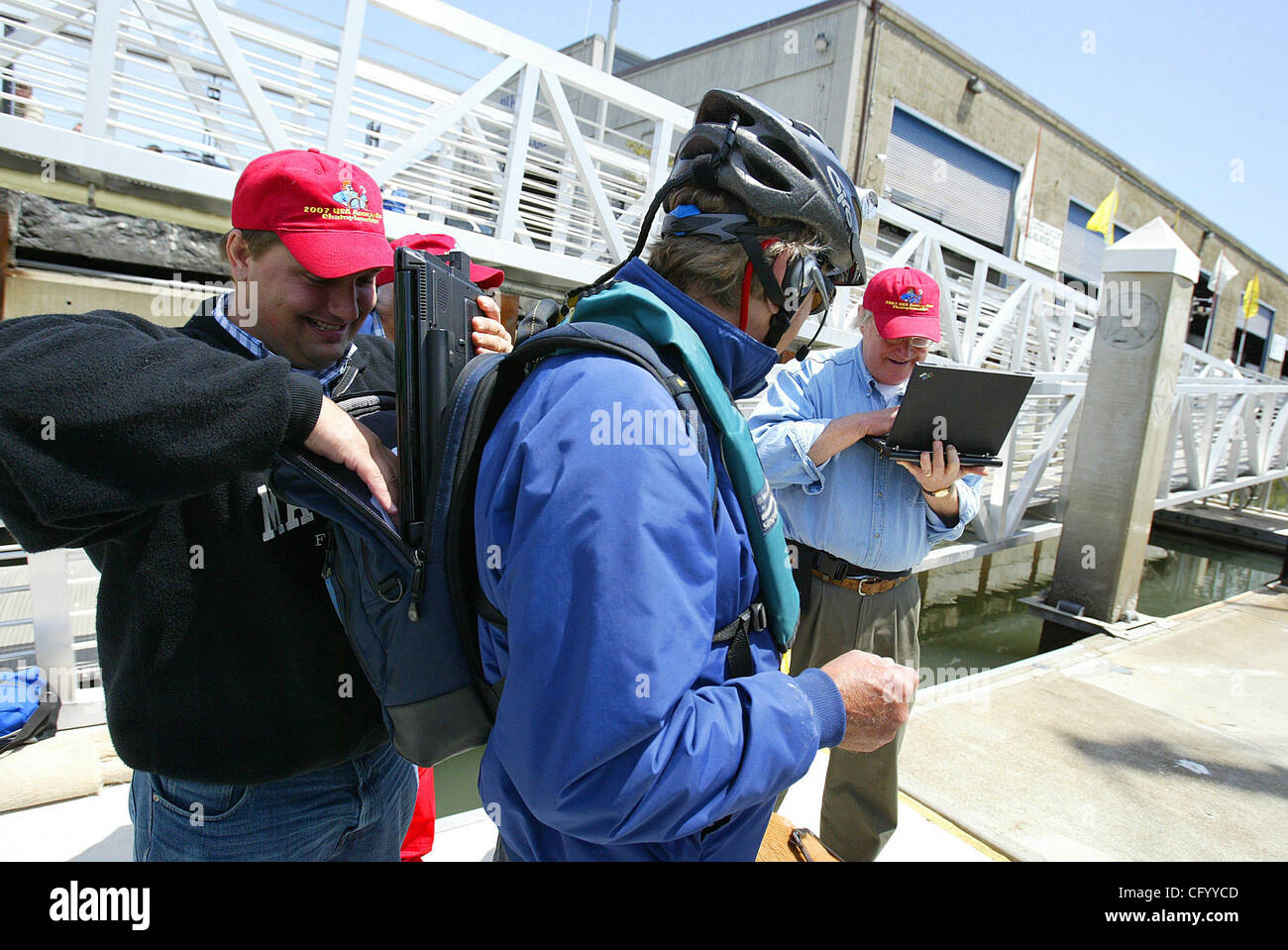 Scott Frost loads a laptop into a backpack for sailor Ed Gallagher ...