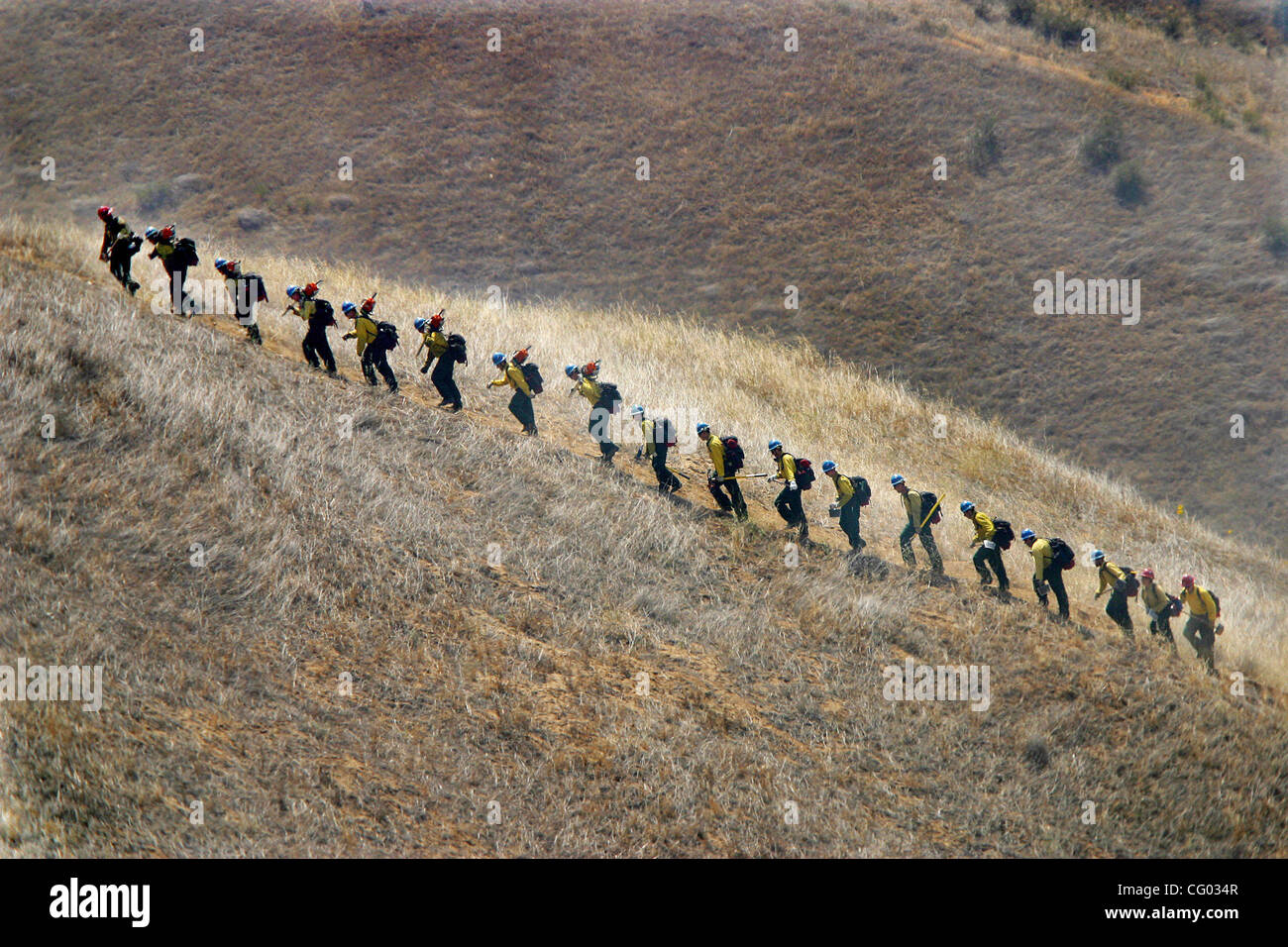 Photo by: Guy Kitchens The Del Rosa Hotshots climb a hill during a ...