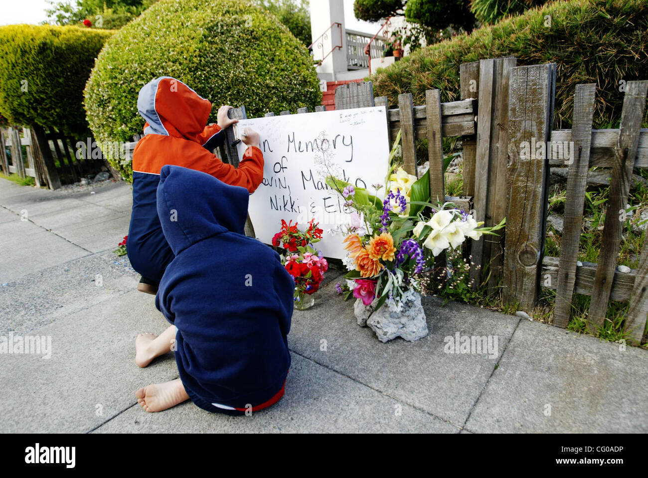 Joshua Friedkin, 8, left, writes a thought as his brother Aaron looks ...