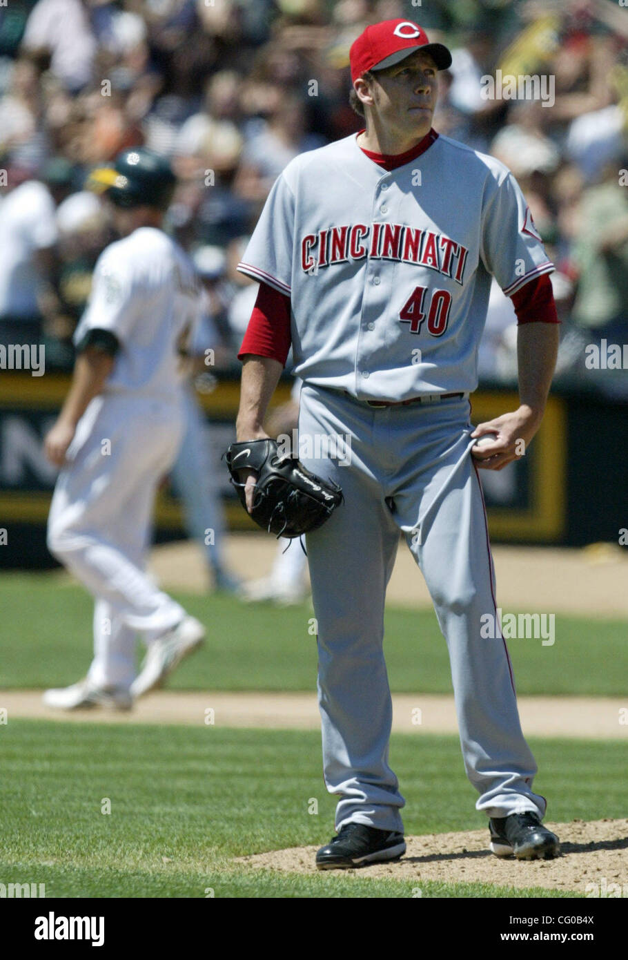Reds pitcher Jon Coutlangus walks A's Nick Swisher to score Bobby ...