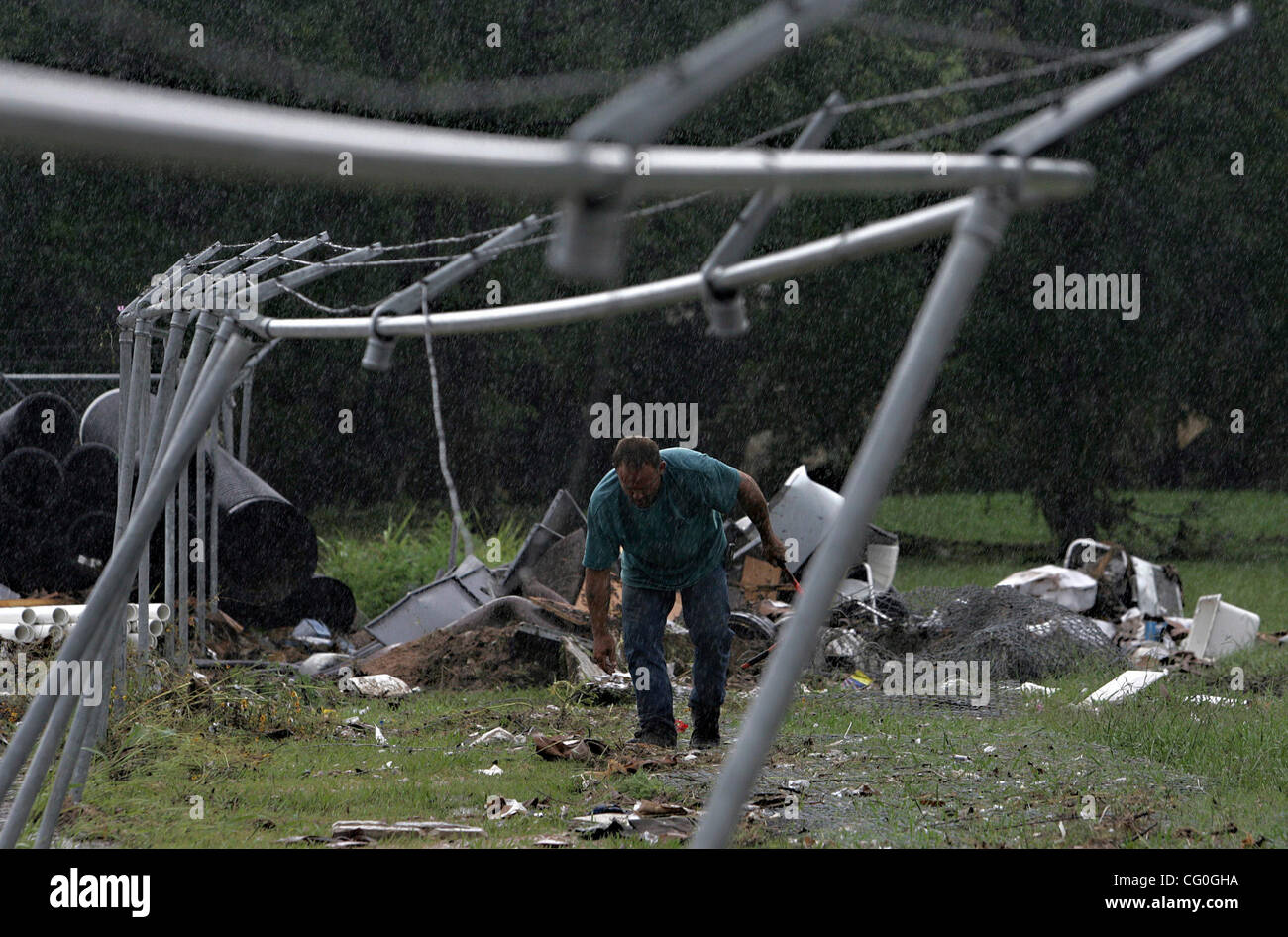 METRO - Tony Burkholder works to repair a fence Thursday, June 28, 2007 ...