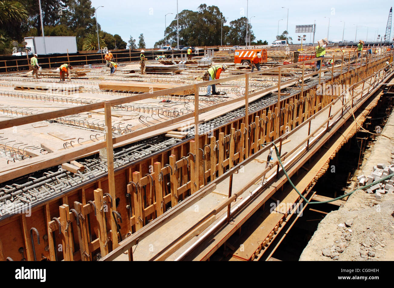 Bridge workers construct a moveable roadway weighing 65 hundred tons at ...