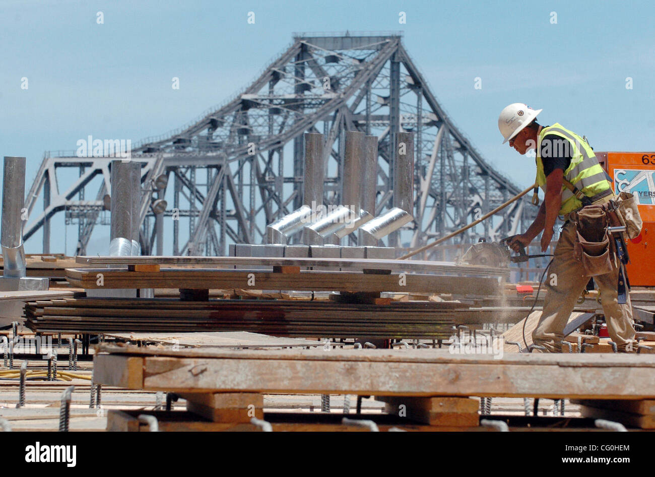 Bridge workers construct a moveable roadway weighing 65 hundred tons at ...