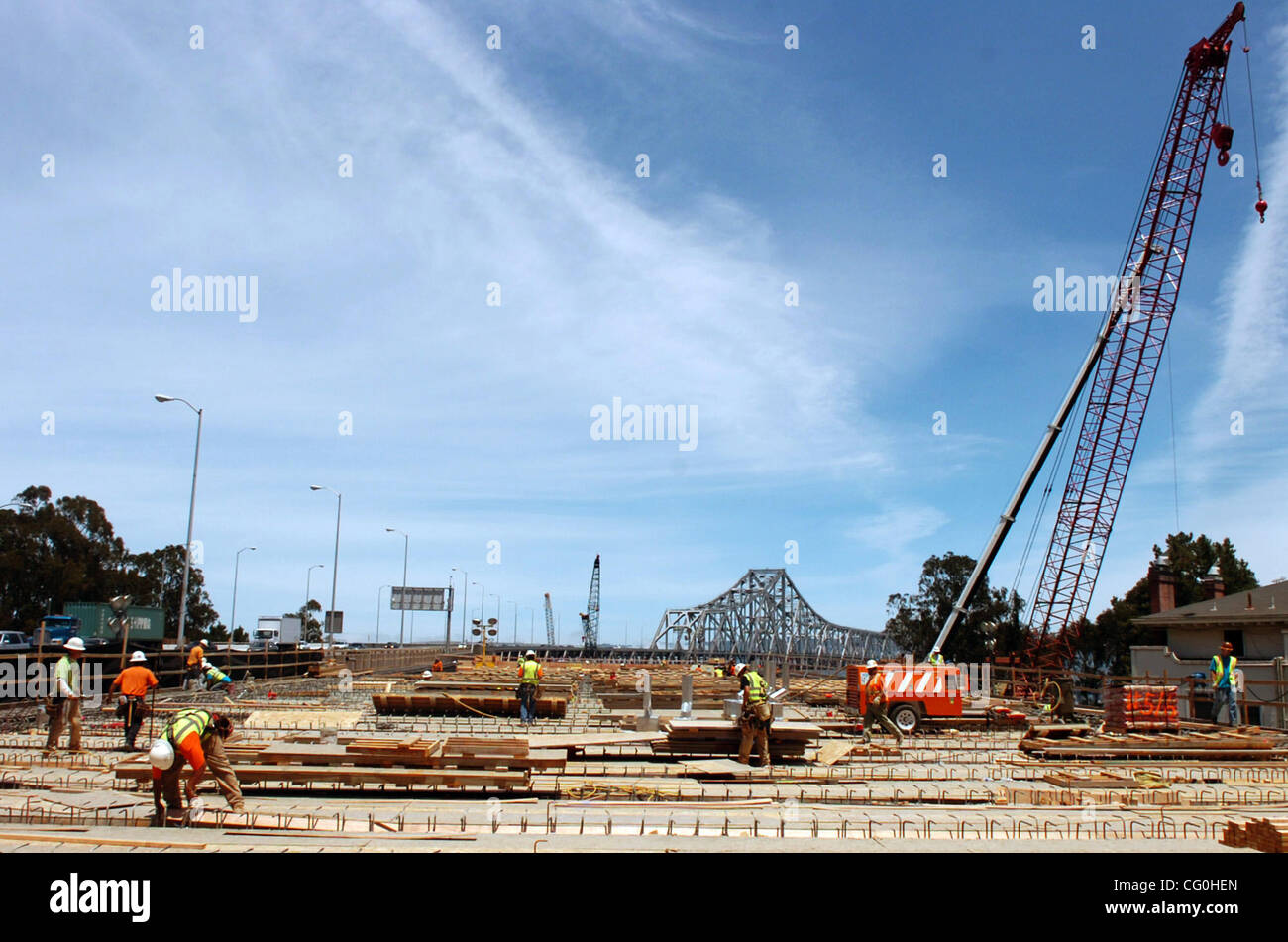 Bridge workers construct a moveable roadway weighing 65 hundred tons at ...