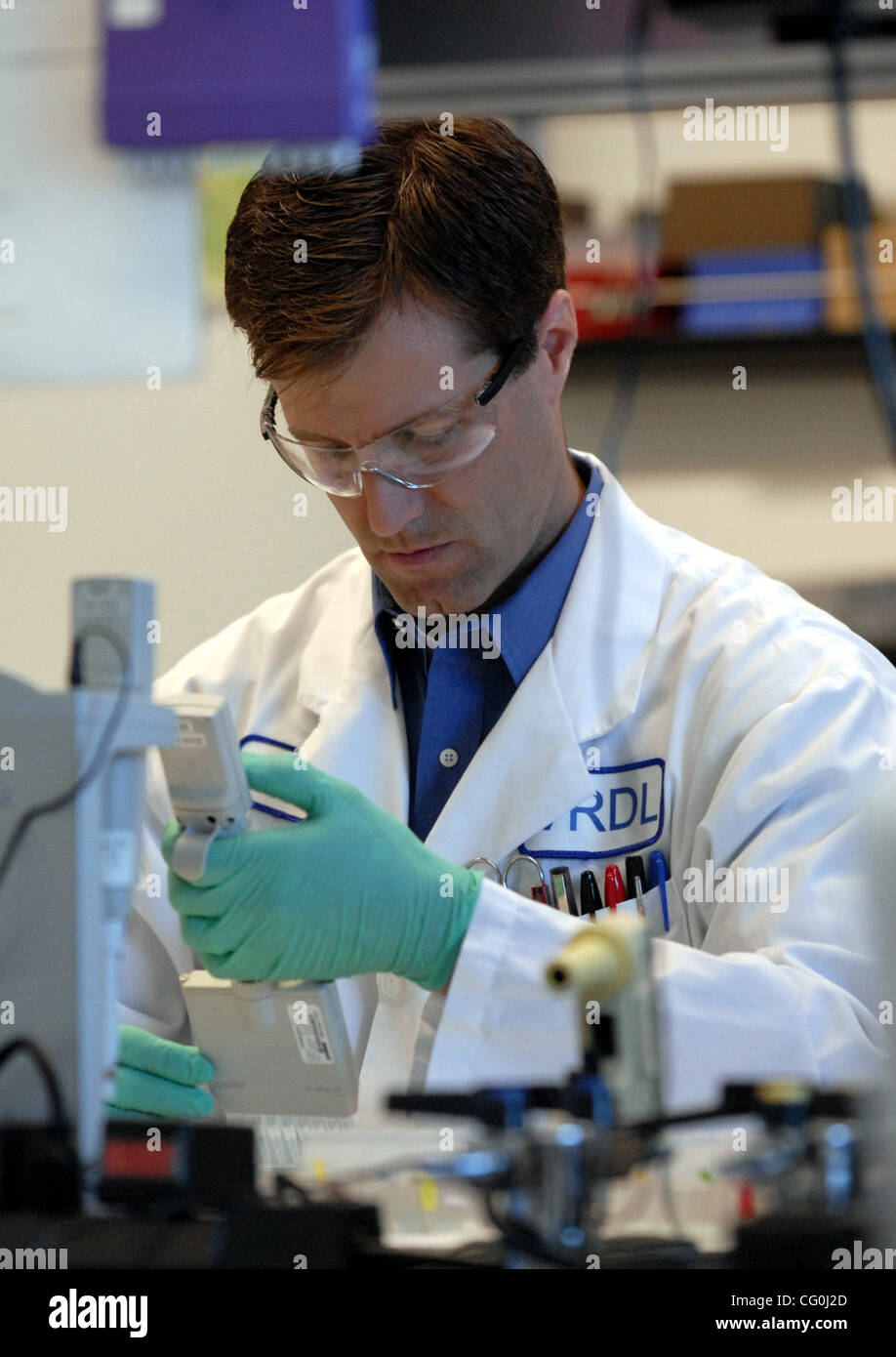 (l to r) Chris Preas demonstrates how he conducts his West Nile ...