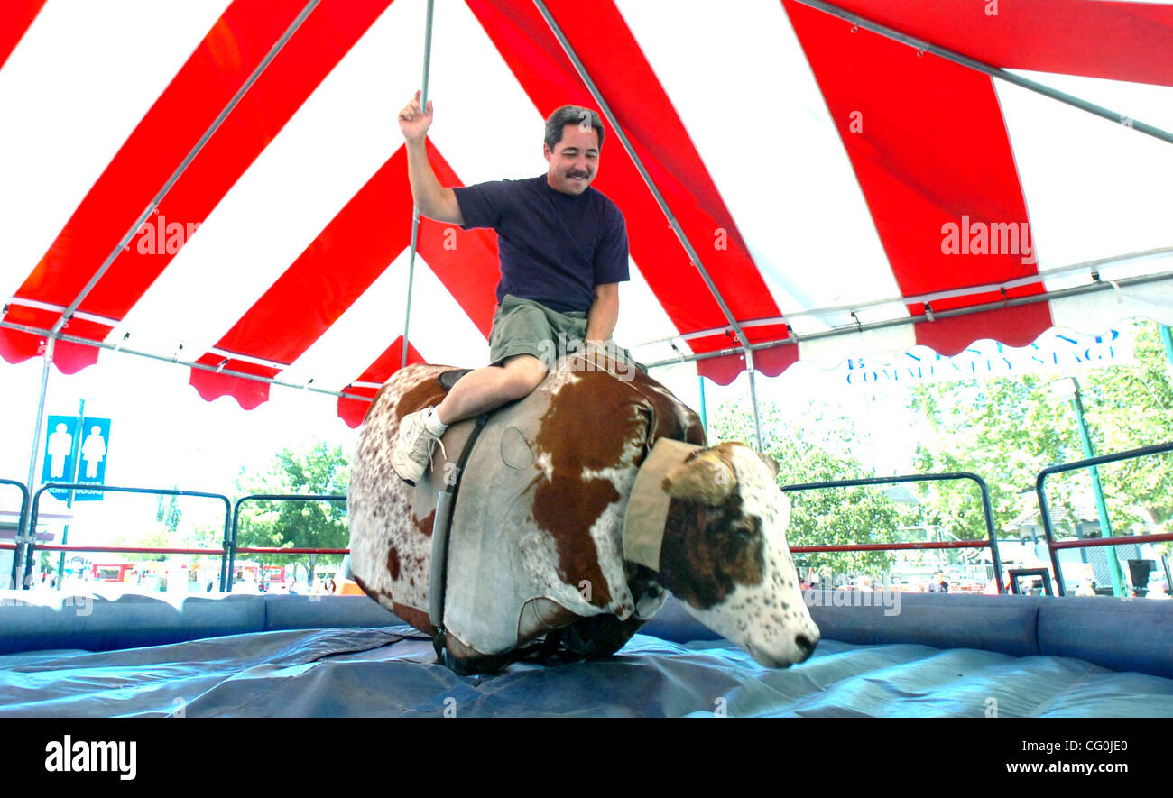 Roy Davis of Livermore, Calif., rides the mechanical bull "Mr. Twister ...