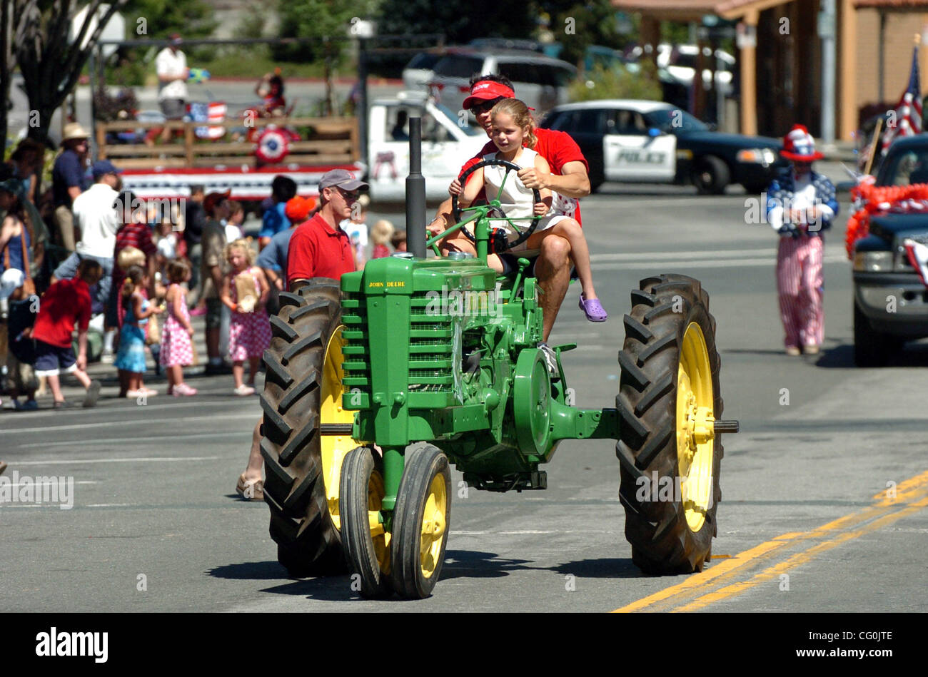 Joe Goldsmith and his daughter Caitlin, 6, drive their tractor in the ...